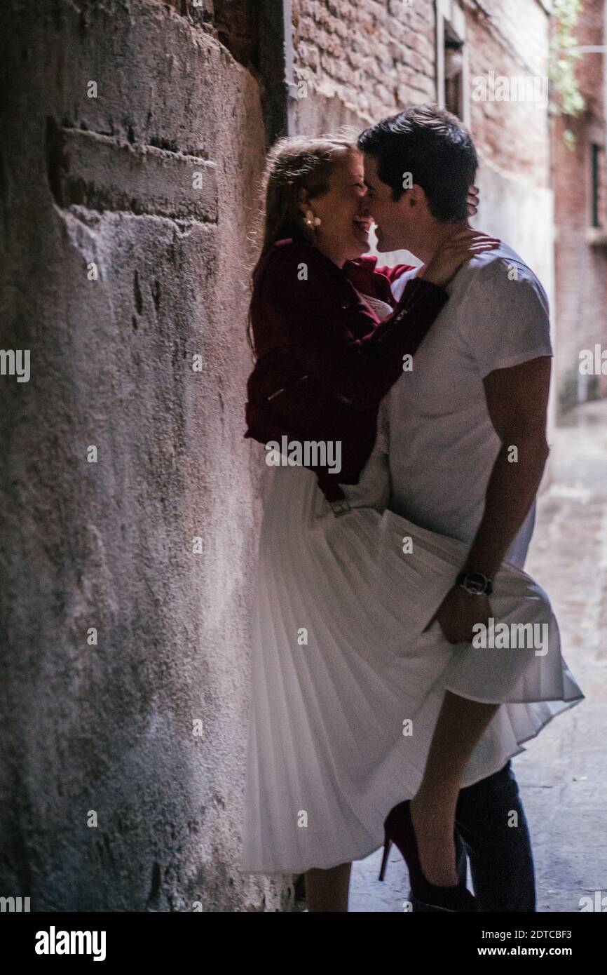 Young Couple Kissing Against Wall High Resolution Stock Photography and ...