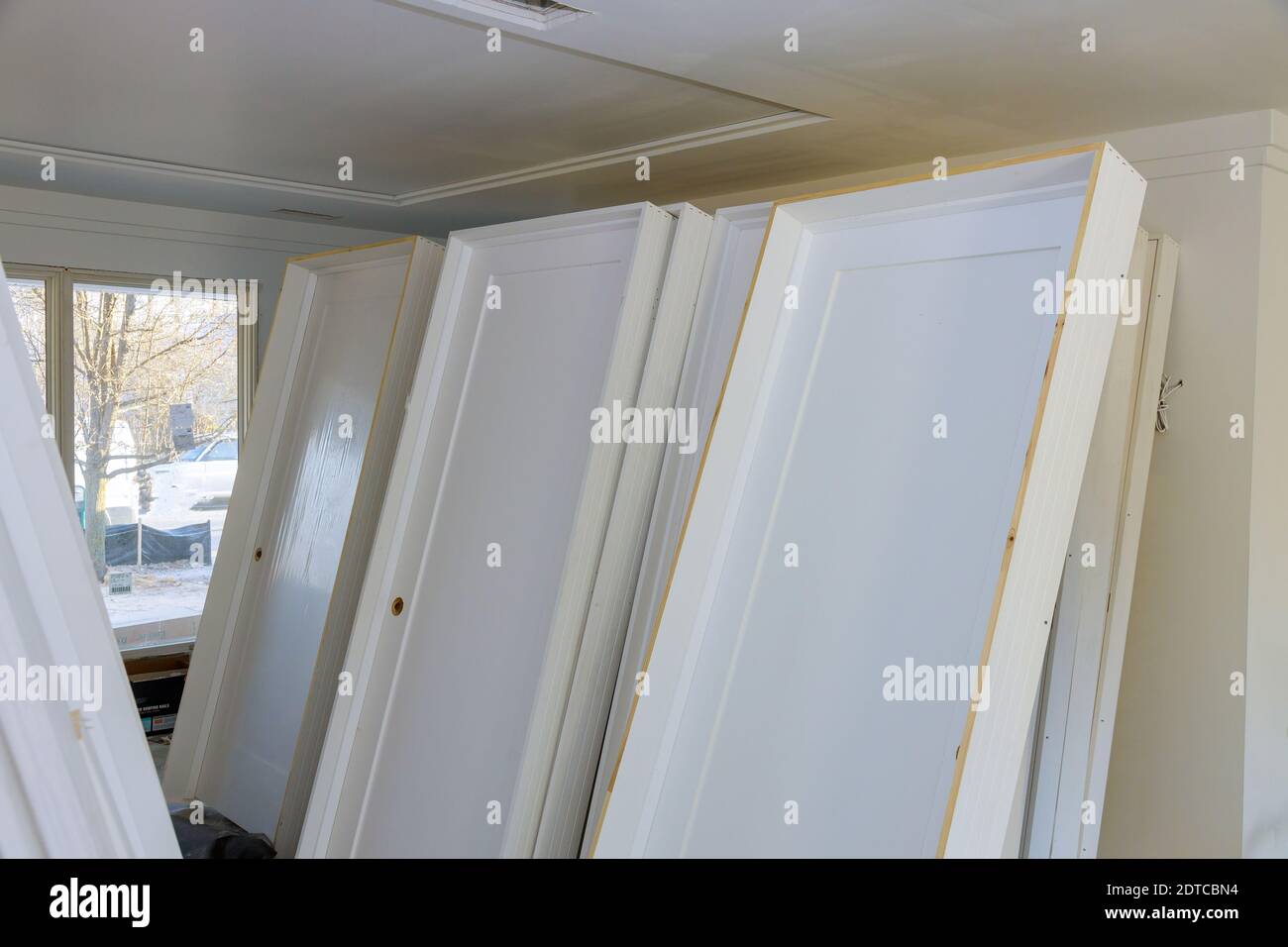 Interior wooden stacker door installation,apartment building, a wait ...