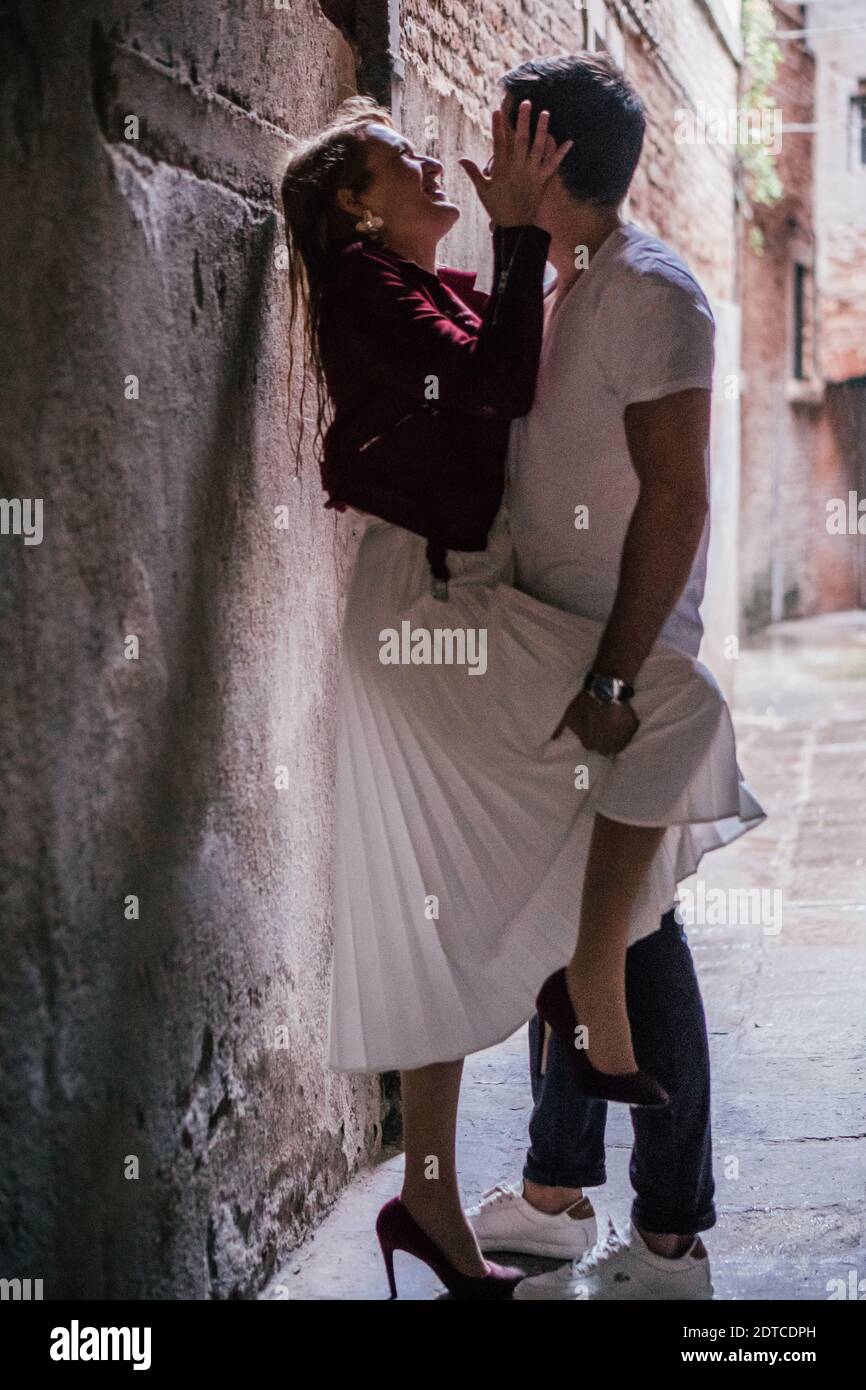 Young Couple Kissing Against Wall High Resolution Stock Photography and ...