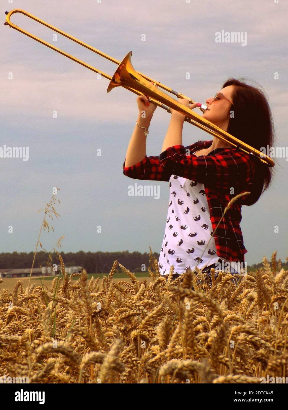 Young woman playing trumpet hi-res stock photography and images - Alamy