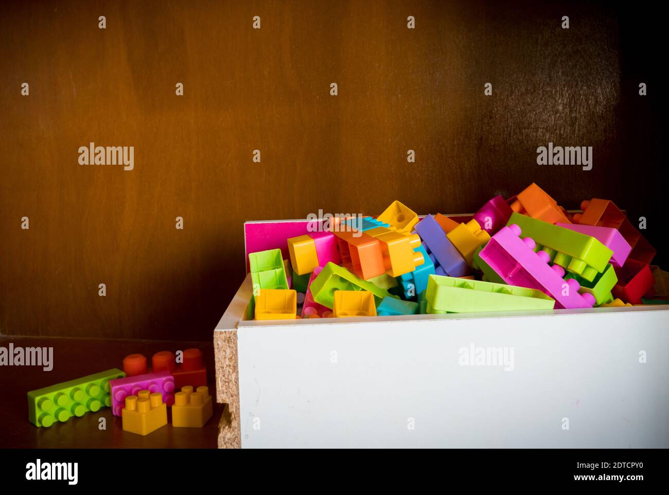 Stack Of Multi Colored Toy Blocks In Container Stock Photo - Alamy