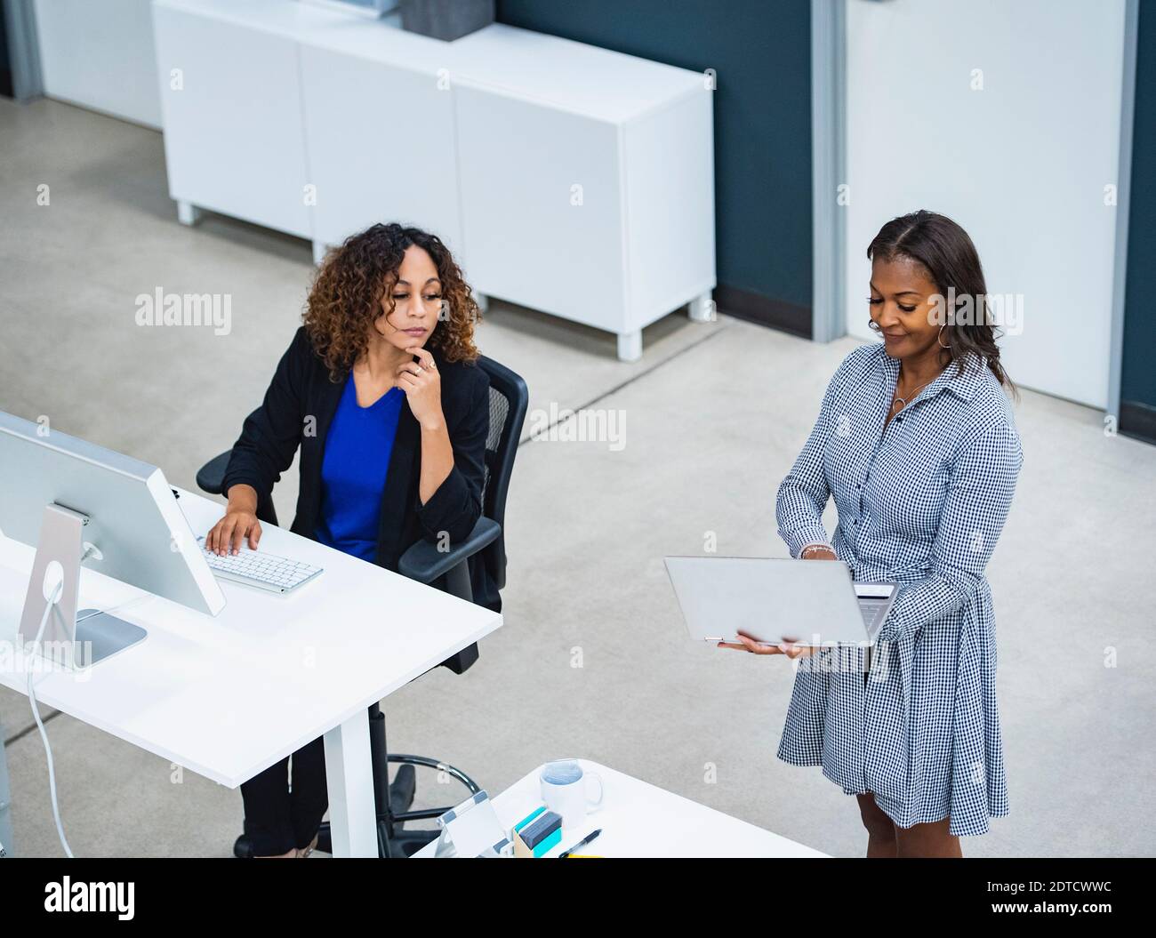 Two women working in office Stock Photo - Alamy