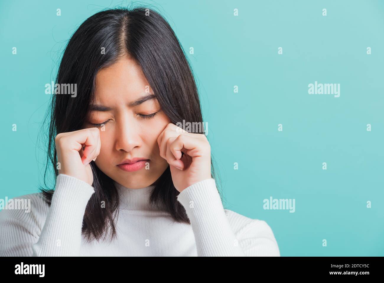 Young asian woman crying while wiping tears hi-res stock photography ...