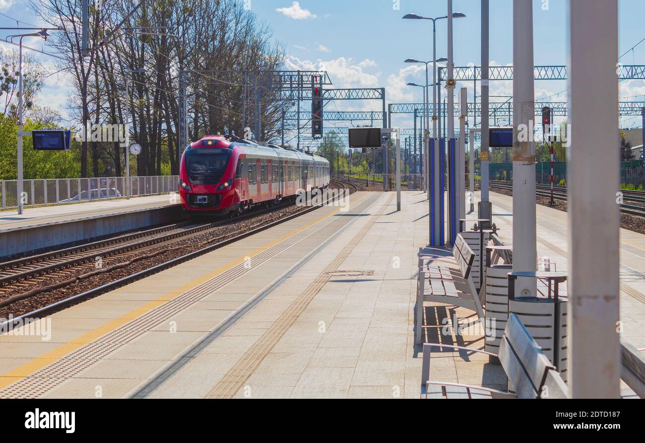 Electric train on the platform of the station. The train is approaching ...