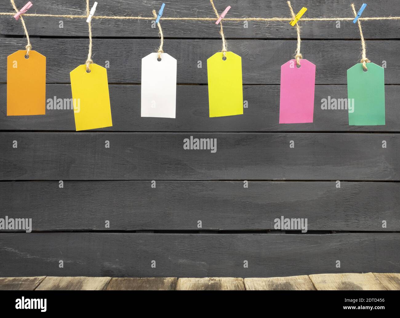 Colored tags are hung on a rope. Labels hanging on a rope with colored ...