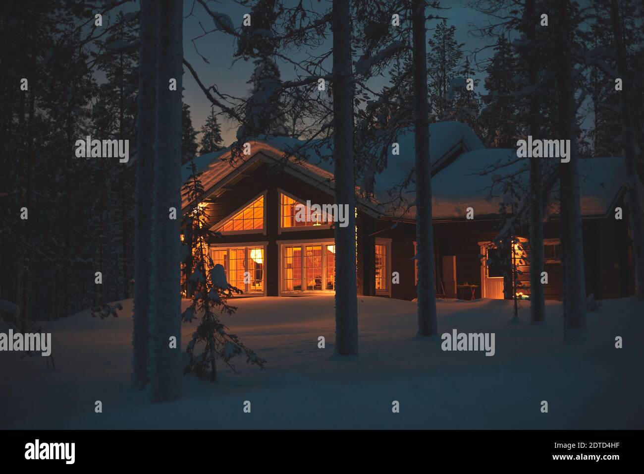 A night view of cozy wooden scandinavian cabin cottage chalet house ...