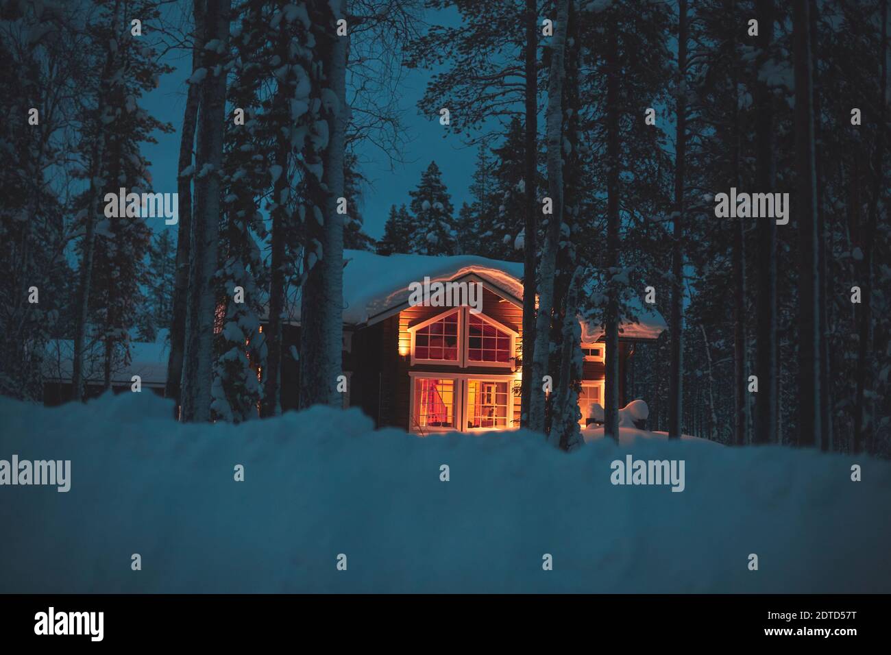 A night view of cozy wooden scandinavian cabin cottage chalet house ...