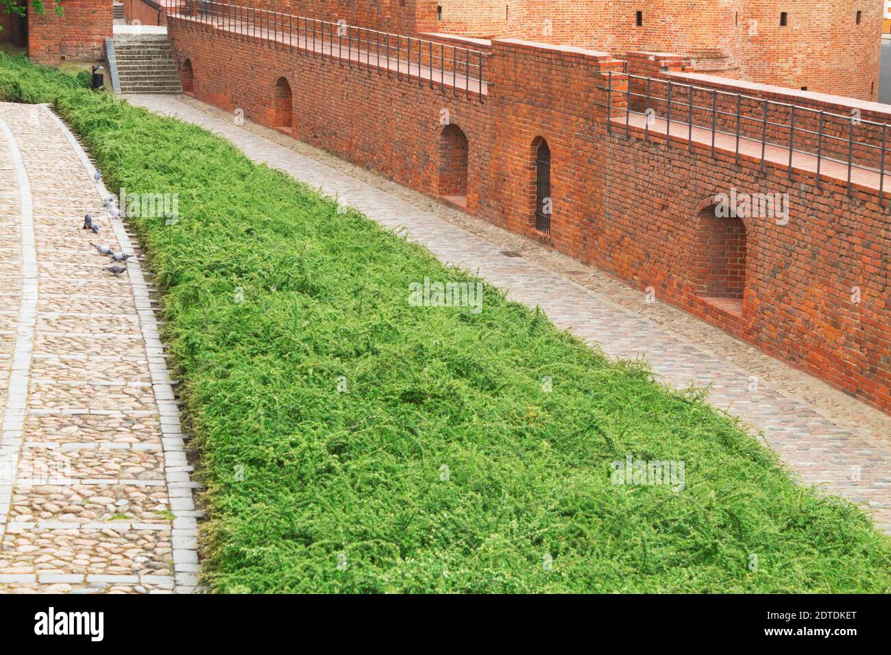 Wall of an ancient castle with walkways and handrails. The wall of the ...