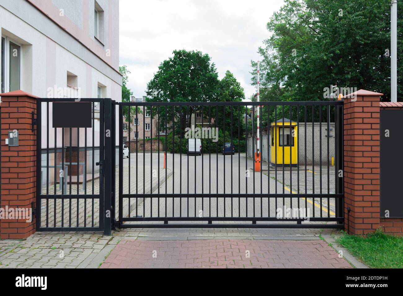 A barrier with a gate and a guard booth. A barrier with a booth and an ...