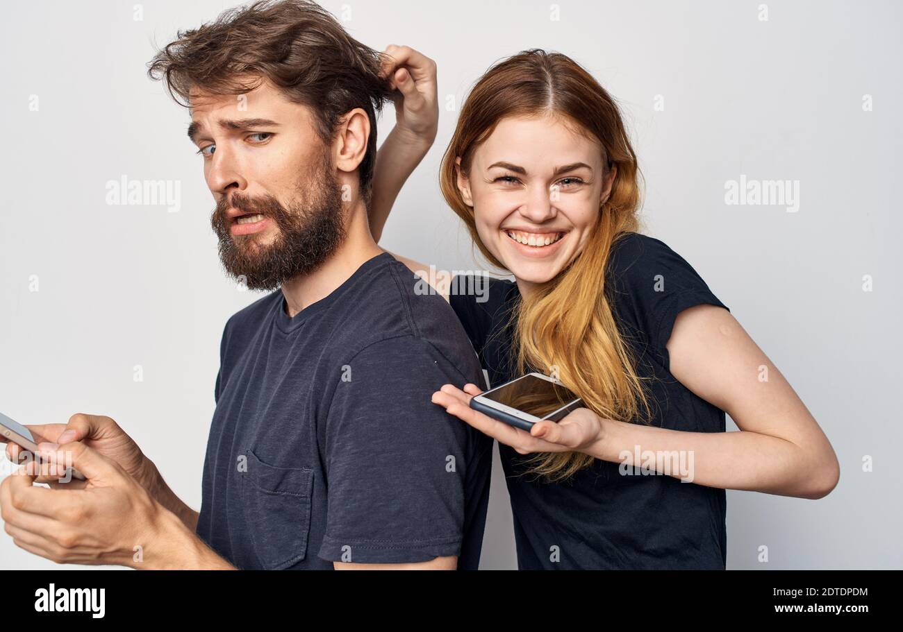 cheerful young couple with phones in hands technology emotions Studio ...