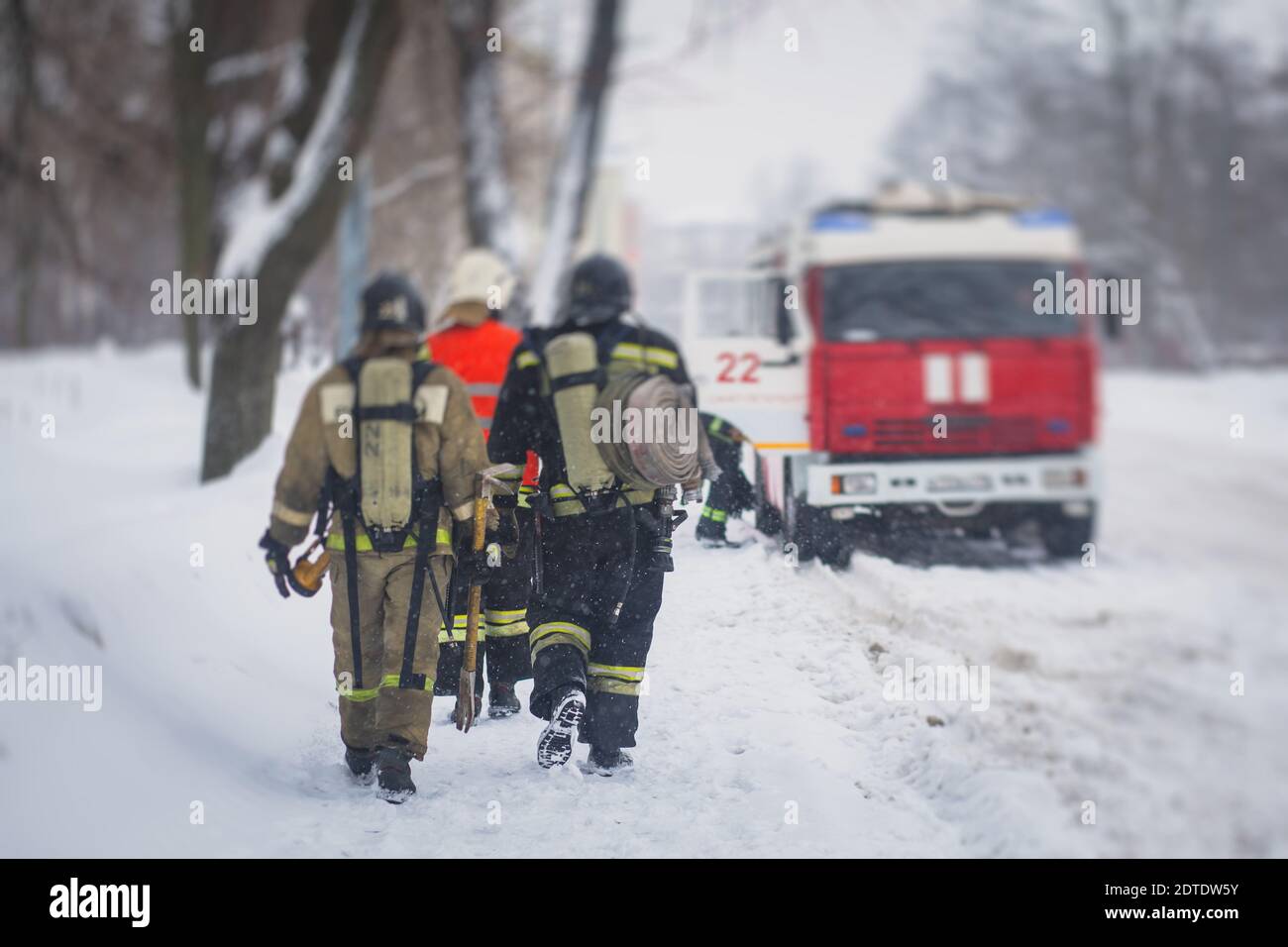 Group of fire men in uniform, firefighters with the a engine truck ...