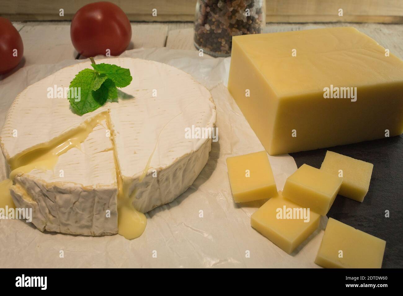 Camembert cheese and gouda cheese side view. Two types of cheese are ...