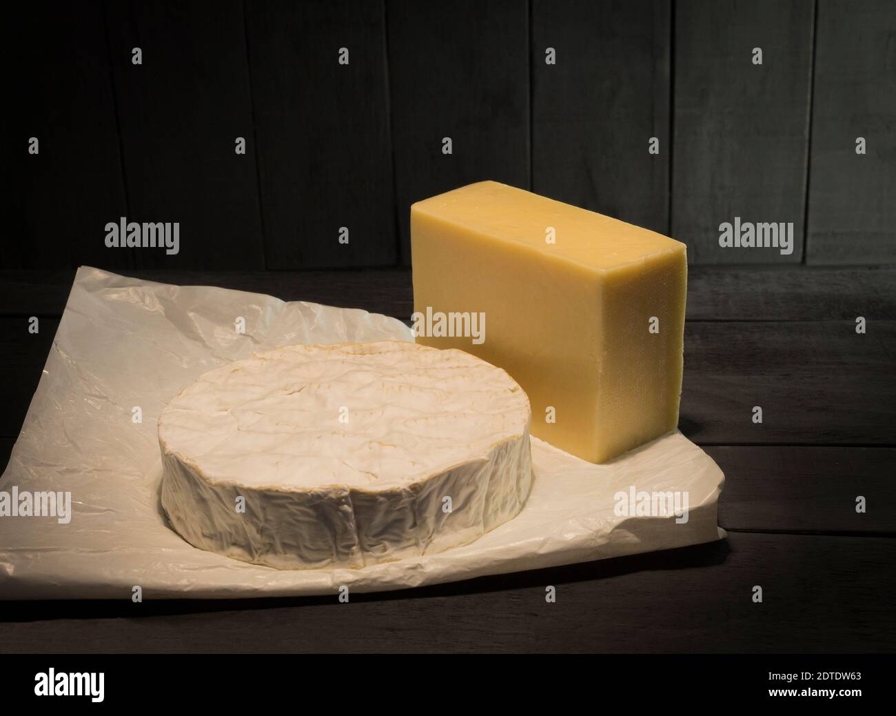 Camembert cheese and gouda cheese side view. Two types of cheese are ...