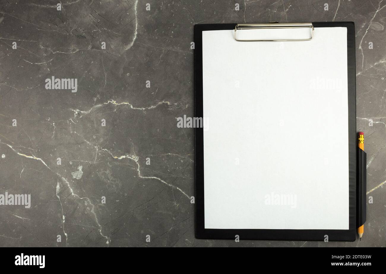 Folder tablet for paper, clipboard with pencil on the table. A4 holder ...