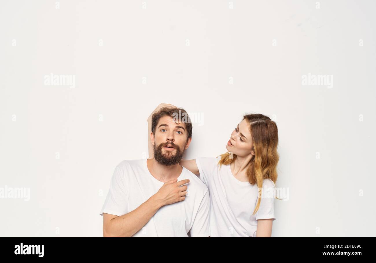 Family couple in white t-shirts fun emotions hug studio cropped view ...
