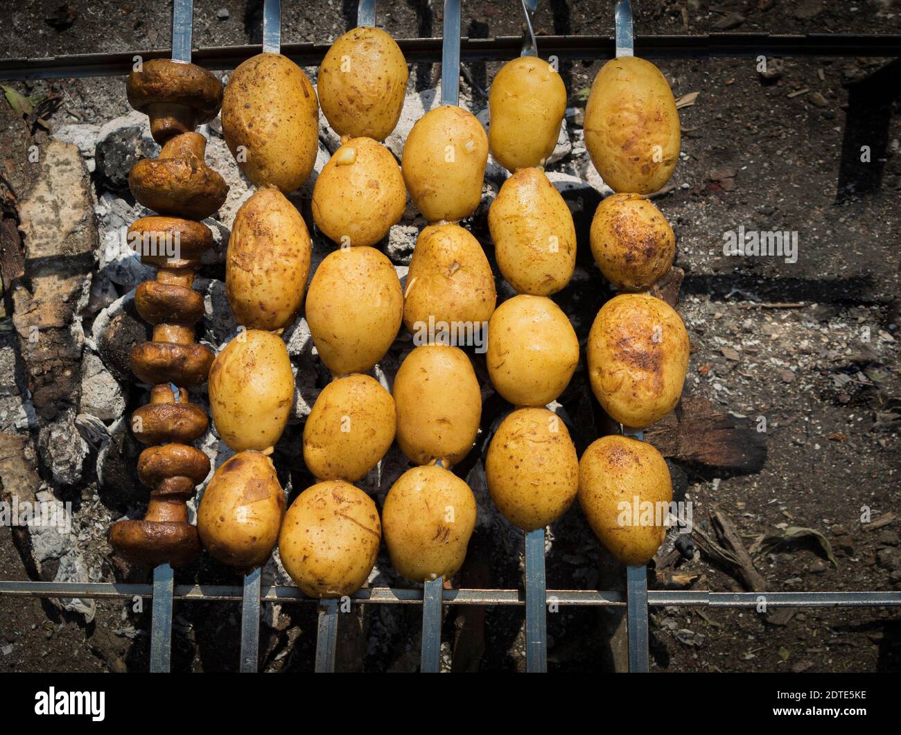 Natural vegetarian and vegan food cooked at the stake. Potatoes and ...