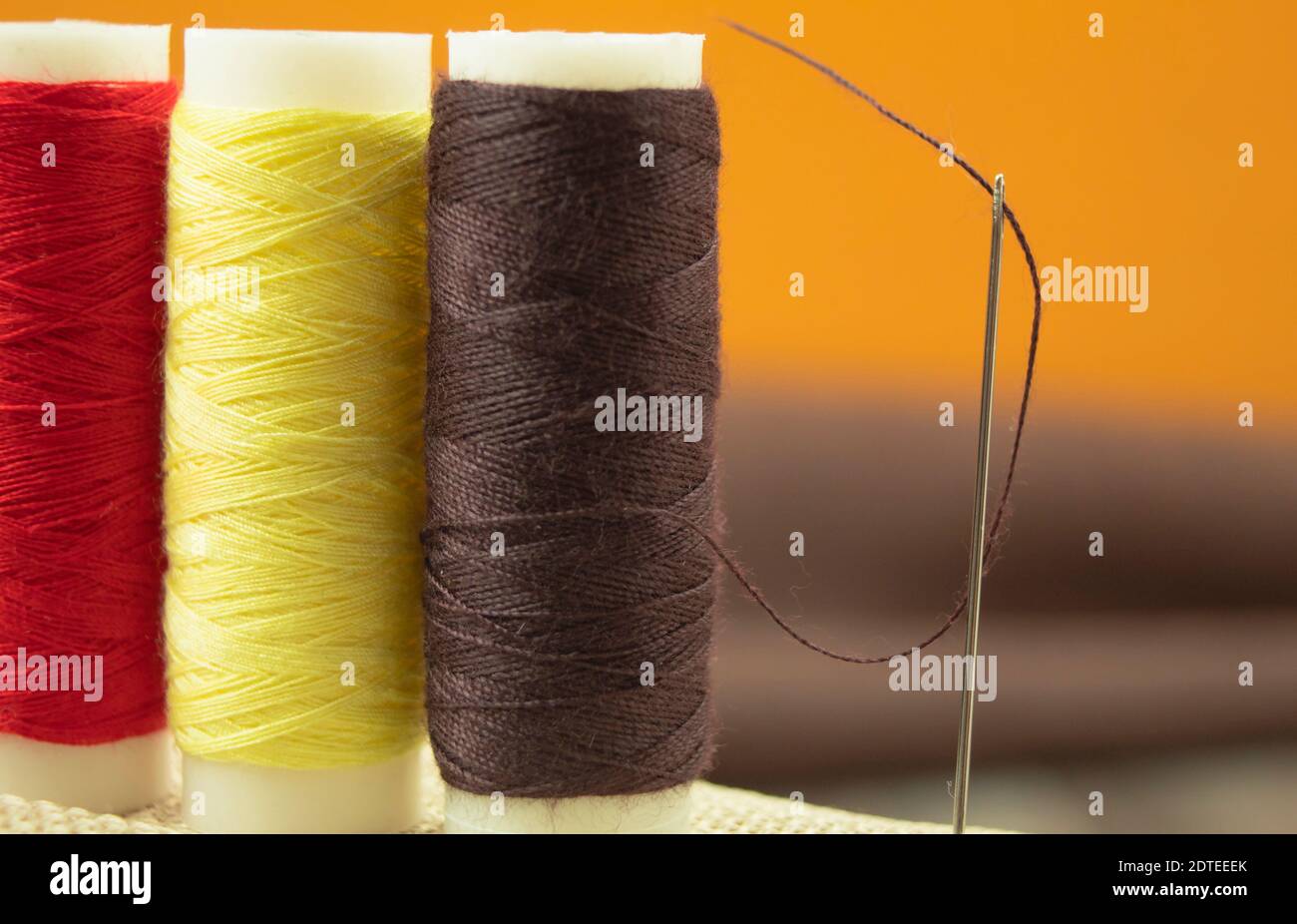 Background for text multi-colored threads and needle for needlework ...