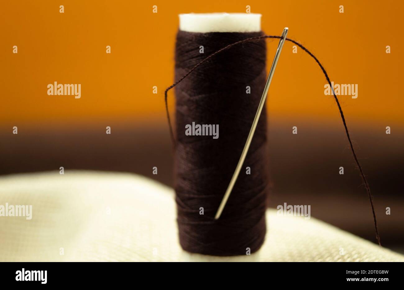 Black thread with a needle background for text Stock Photo - Alamy