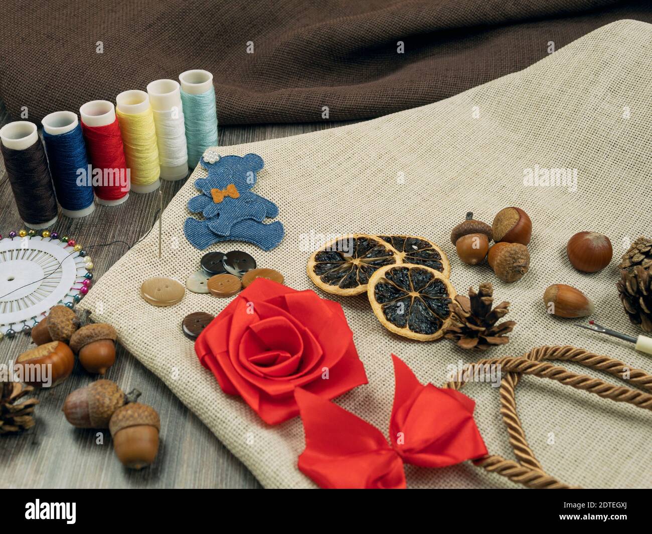 Buttons and thread with a needle as background Stock Photo - Alamy