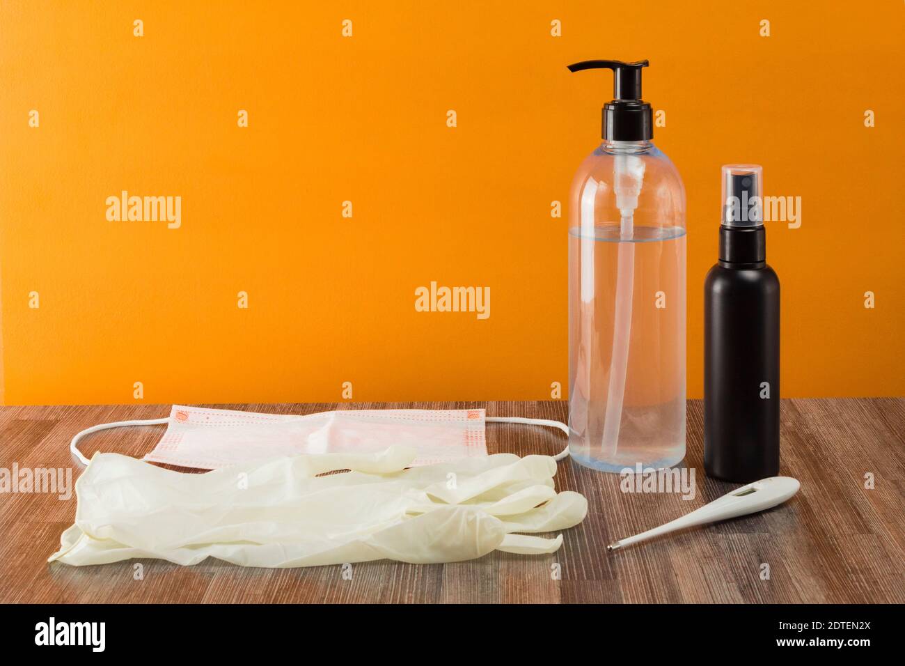 Disinfectant and mask with gloves Stock Photo - Alamy