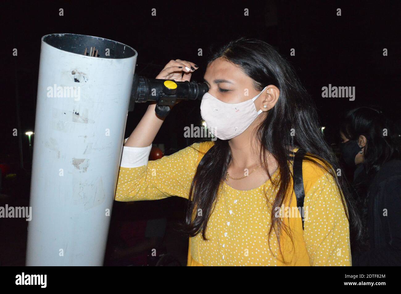 Bangalore, India. 21st Dec, 2020. A visitor observes the celestial ...