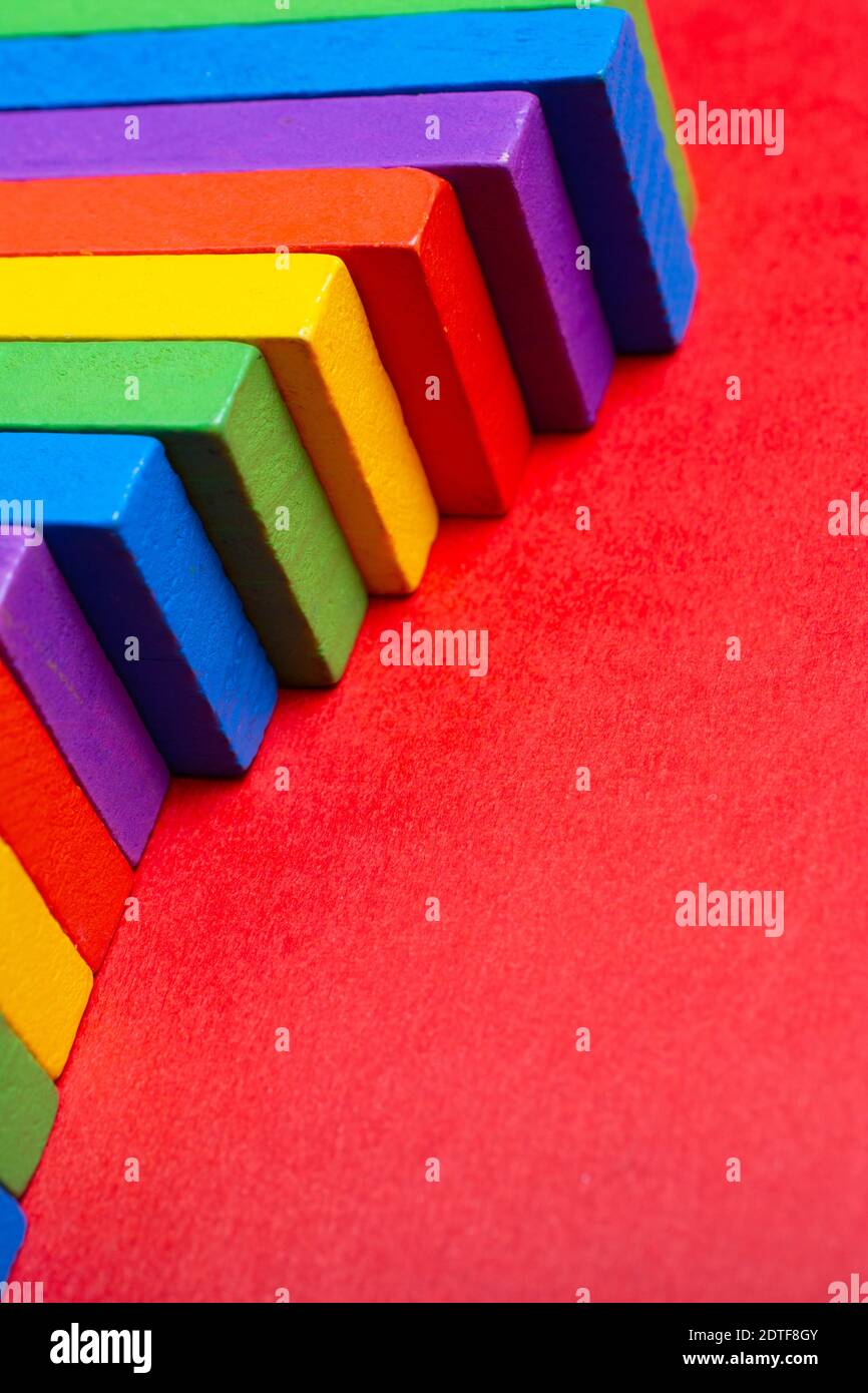 Colorful dominoes. Rainbow colored chain reaction Stock Photo - Alamy
