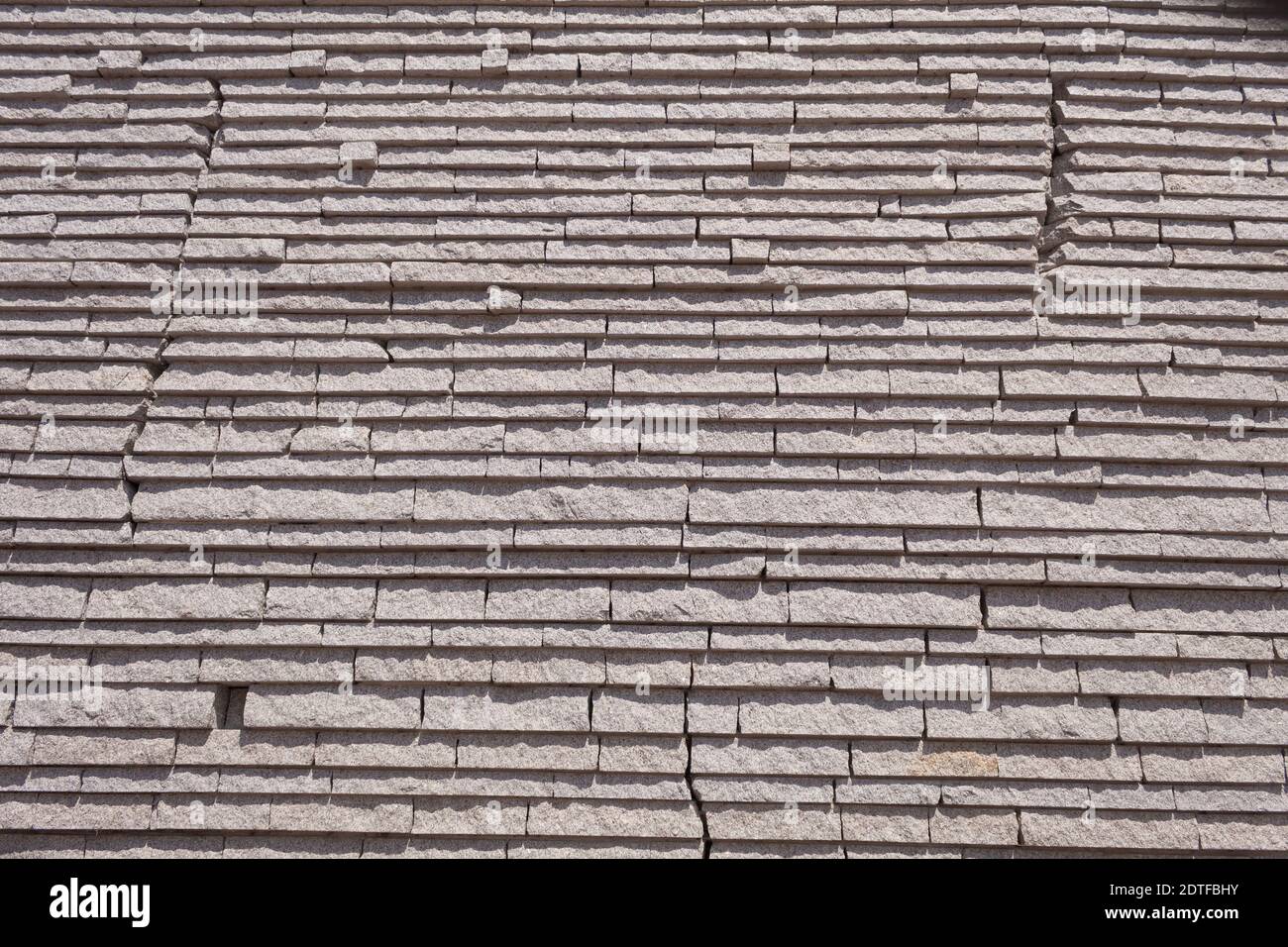 Textured wall made of granite slabs with a cascade Stock Photo - Alamy