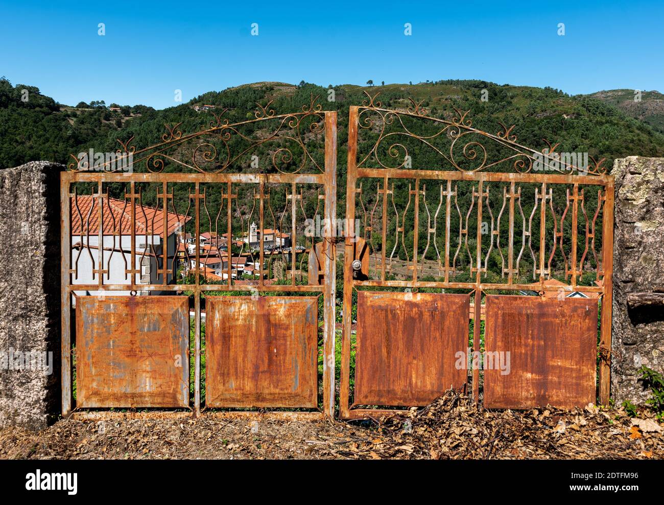 Rusty wrought iron door with mountain and village background Stock ...