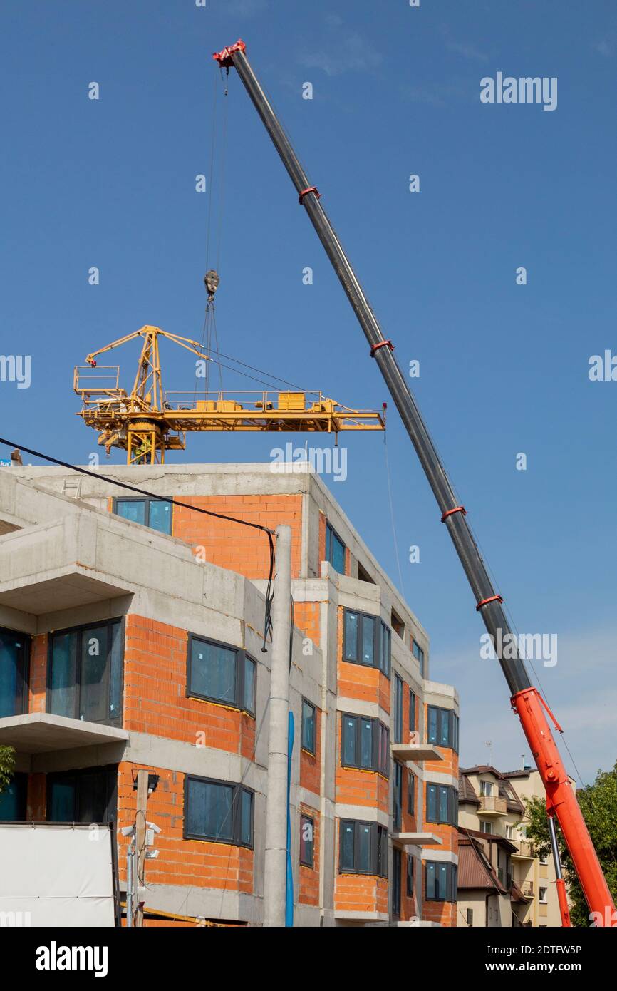 Dismantling and assembling a construction crane. Dismantling a tower ...