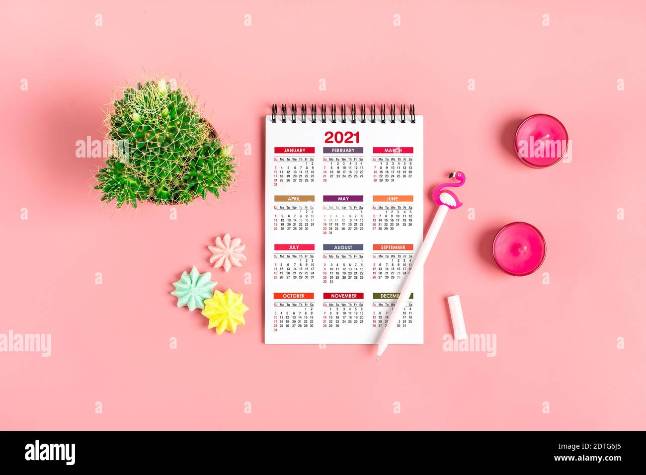 Open Calendar January 2021, candles, pen, sweets, succulents on pink ...
