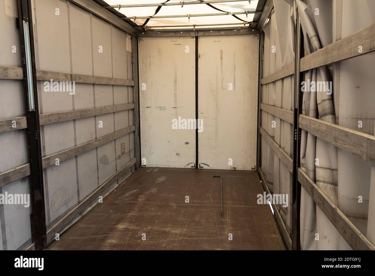 Loading goods onto a truck trailer. Unloading a trailer of pallets with ...