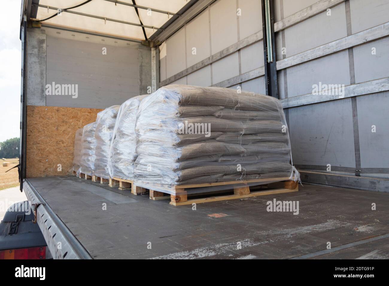 Loading goods onto a truck trailer. Unloading a trailer of pallets with ...