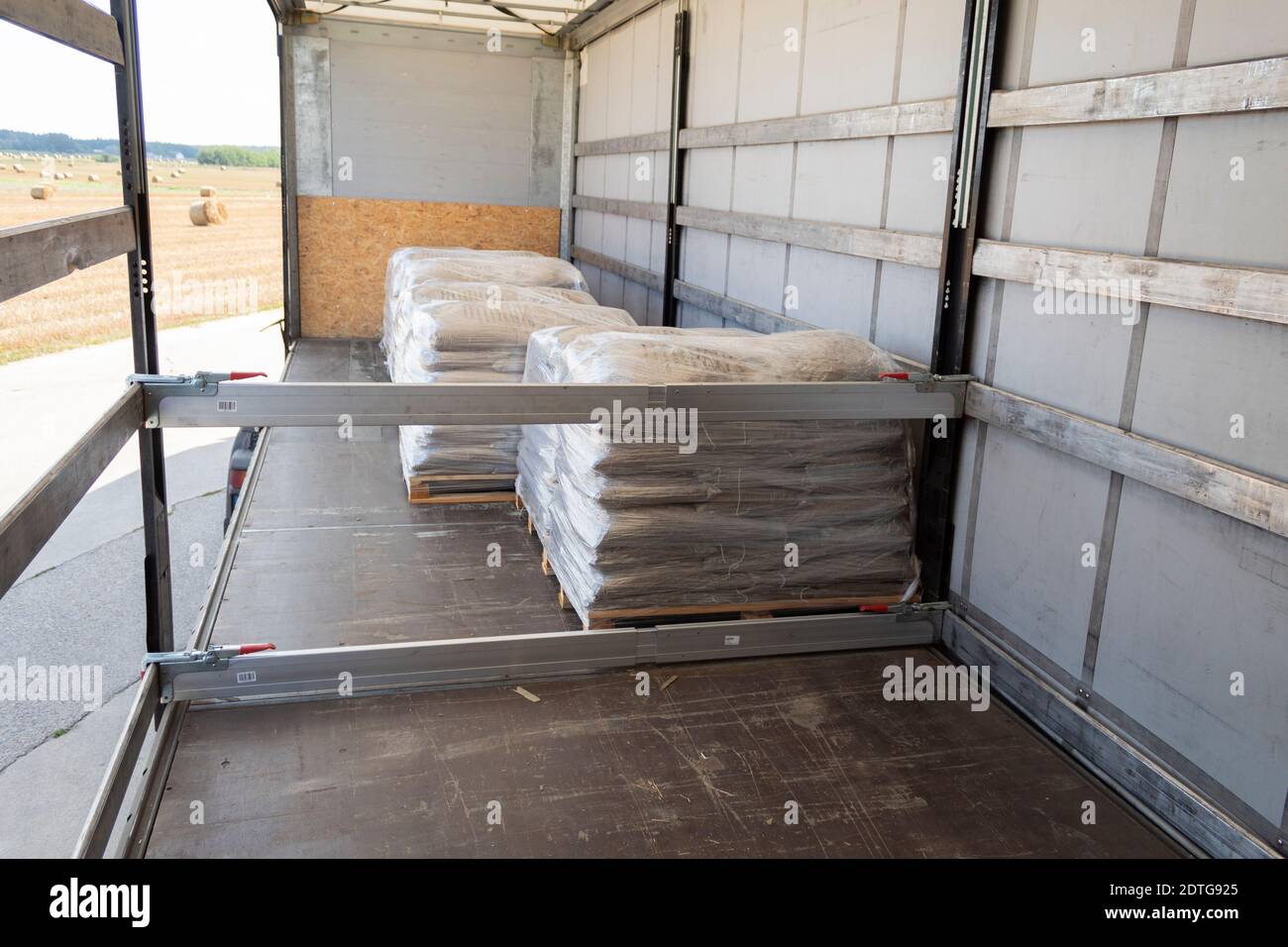 Loading goods onto a truck trailer. Unloading a trailer of pallets with ...
