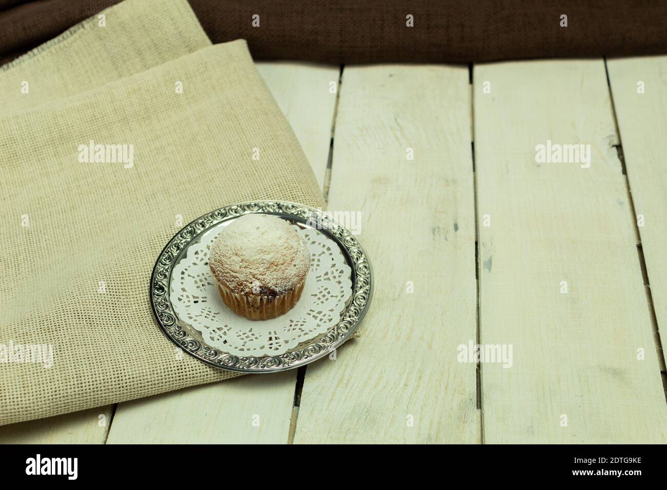 Muffin is sprinkled with icing sugar. Homemade cupcake background for ...
