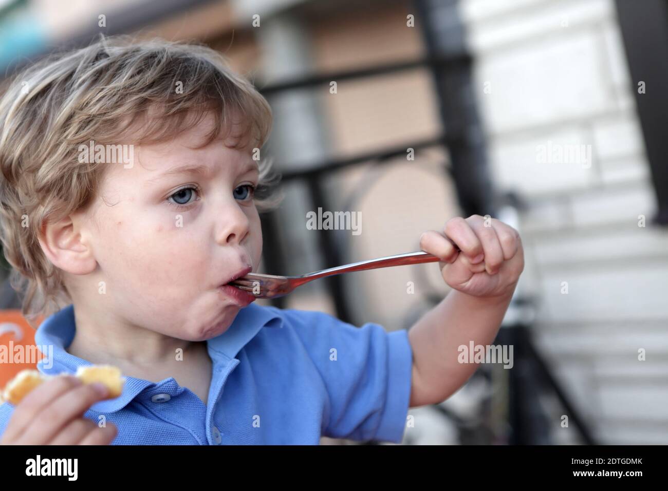 Hungry boy has lunch in a restaurant Stock Photo - Alamy