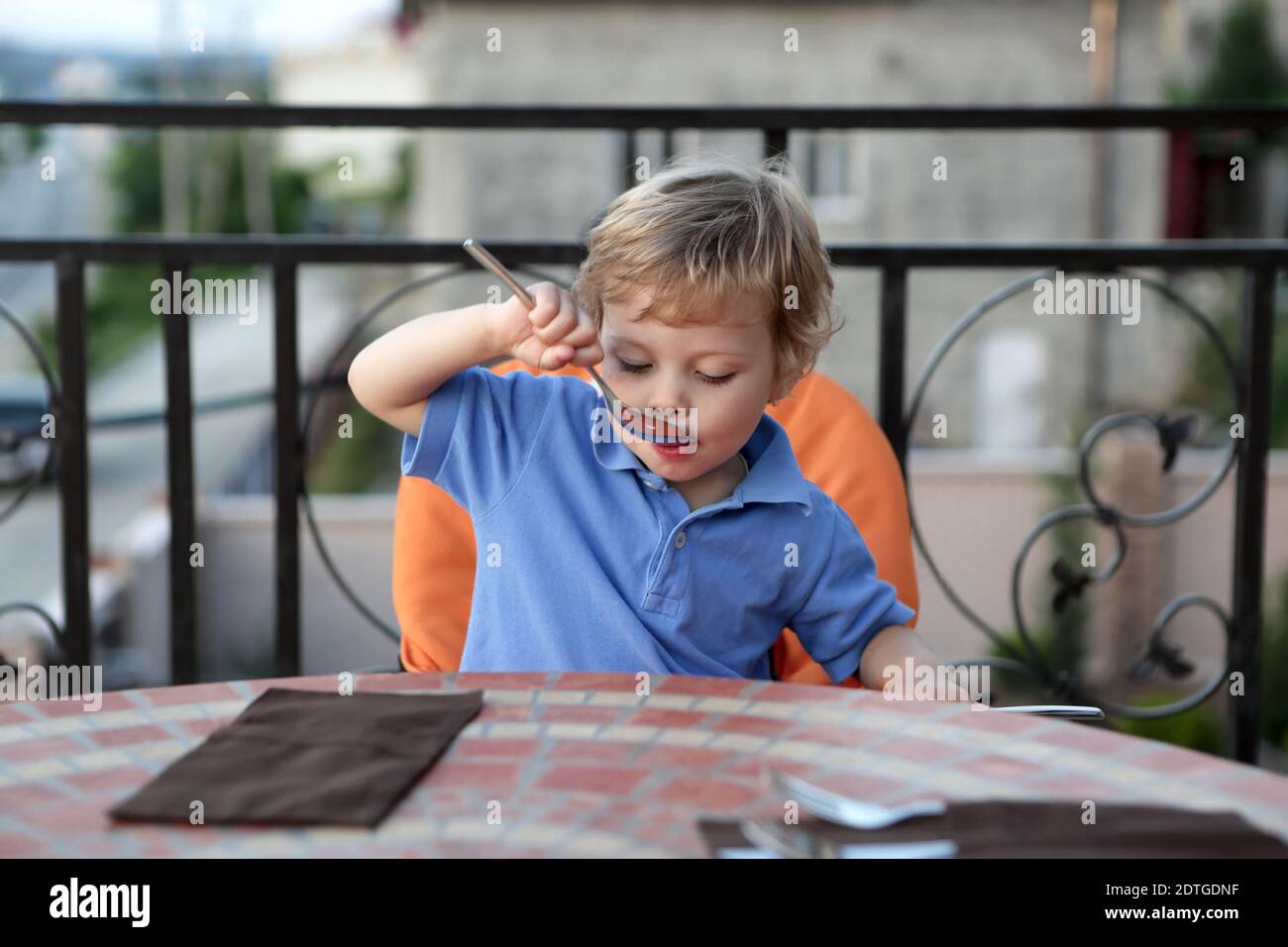 Hungry child has lunch in a restaurant Stock Photo - Alamy