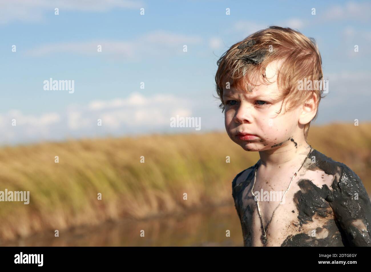 Portrait of a kid in healing mud Stock Photo - Alamy