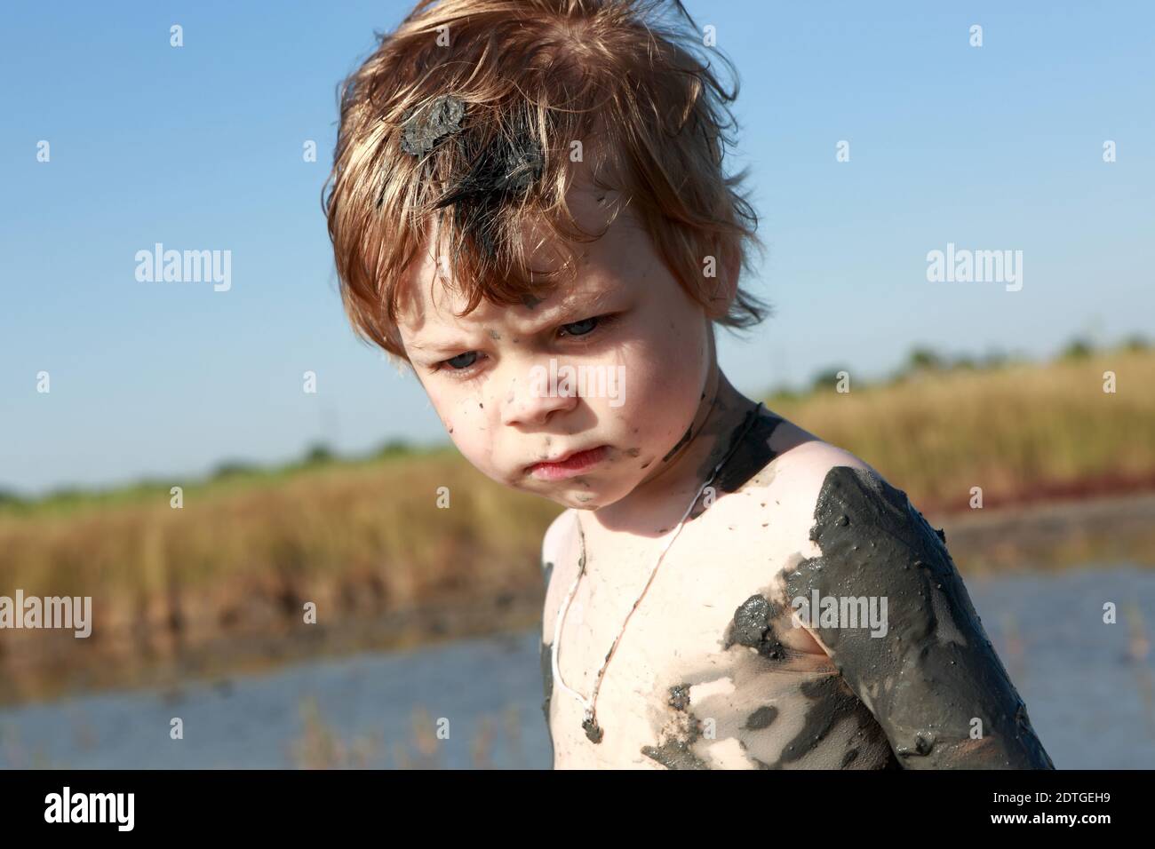 Portrait of a serious kid in healing mud Stock Photo - Alamy