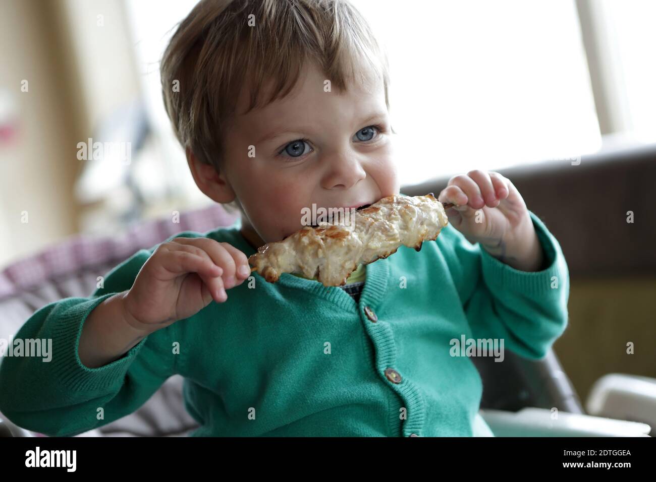 Child eating kebab on stick in a cafe Stock Photo - Alamy