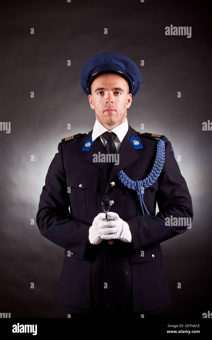 elegant soldier wearing uniform in studio with gun Stock Photo - Alamy