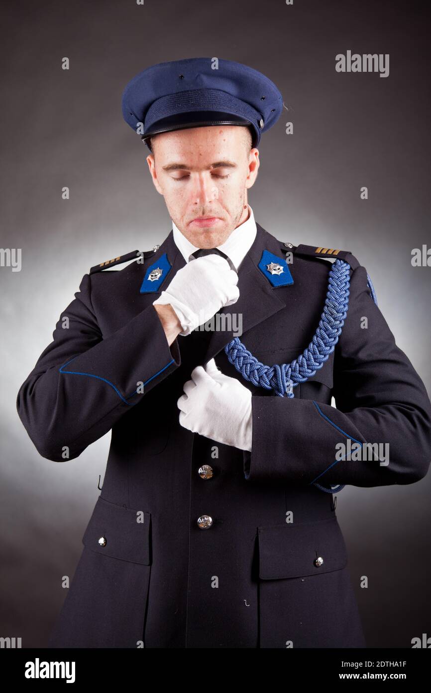 elegant soldier wearing uniform in studio with gun Stock Photo - Alamy