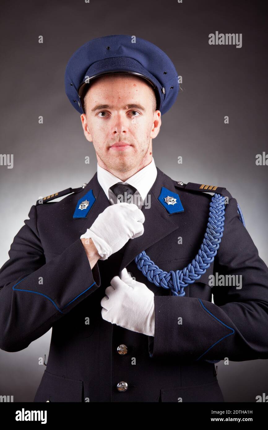 elegant soldier wearing uniform in studio with gun Stock Photo - Alamy