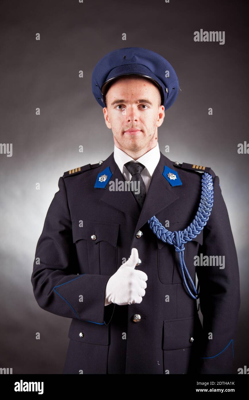 elegant soldier wearing uniform in studio with gun Stock Photo - Alamy