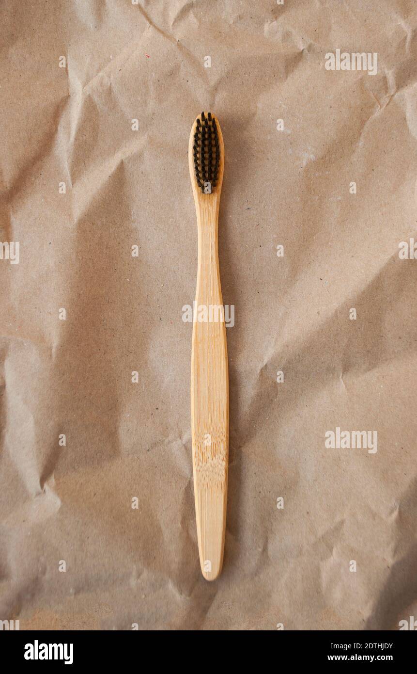 Single bamboo toothbrush on beige paper background. Zero watse concept ...