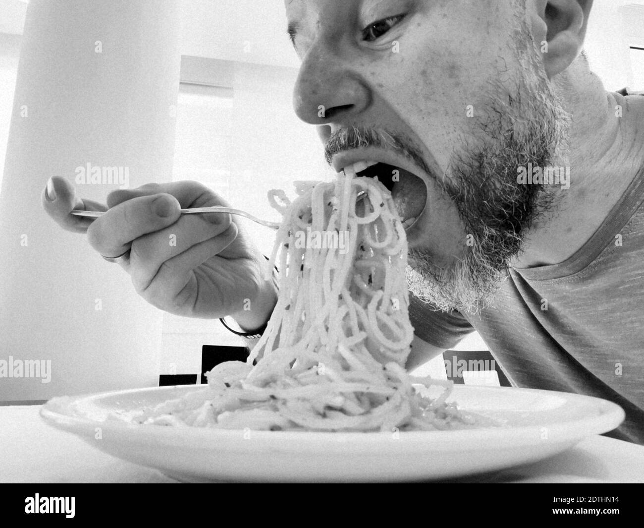 Man hand eating Black and White Stock Photos & Images - Alamy