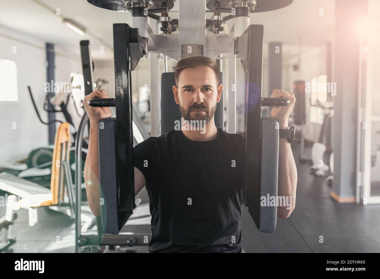 Man working hard at the gym. Pectoral muscles exercises with training ...