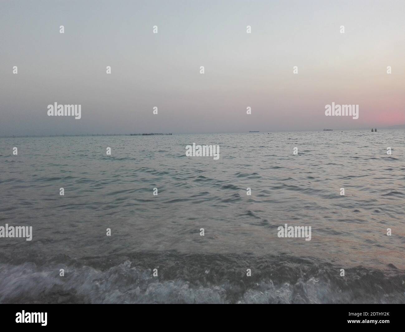 A calm seascape view in the evening under a clear sky Stock Photo - Alamy