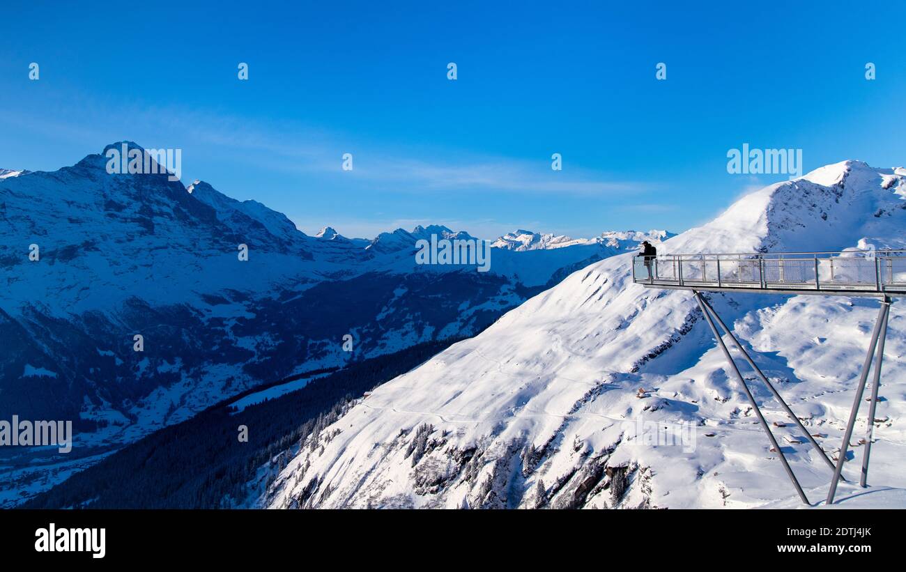 A tourist standing on a metal structure and admiring the mighty ...