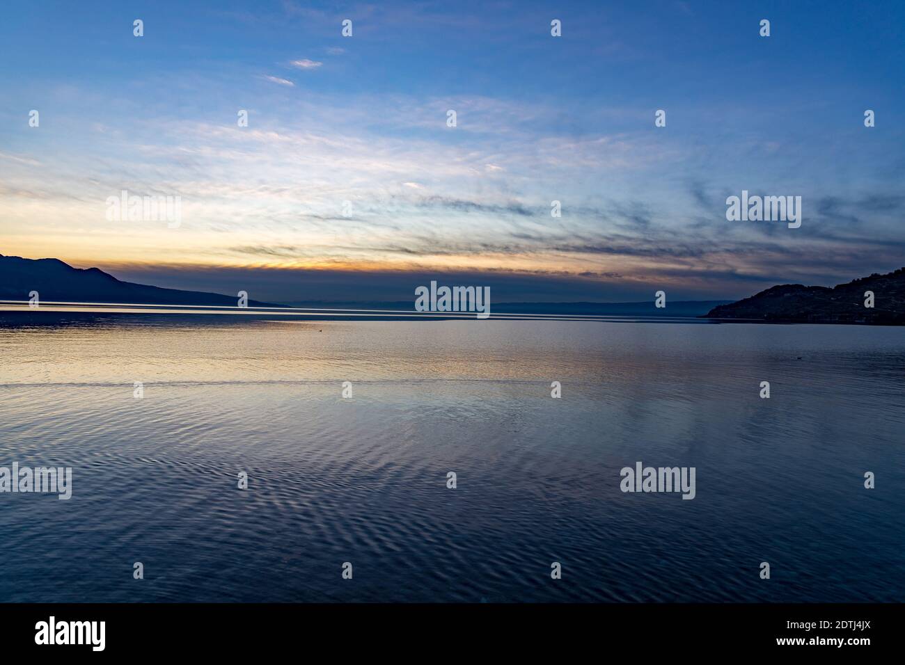 A mesmerizing view of a wavy lake on background of yellow and blue ...