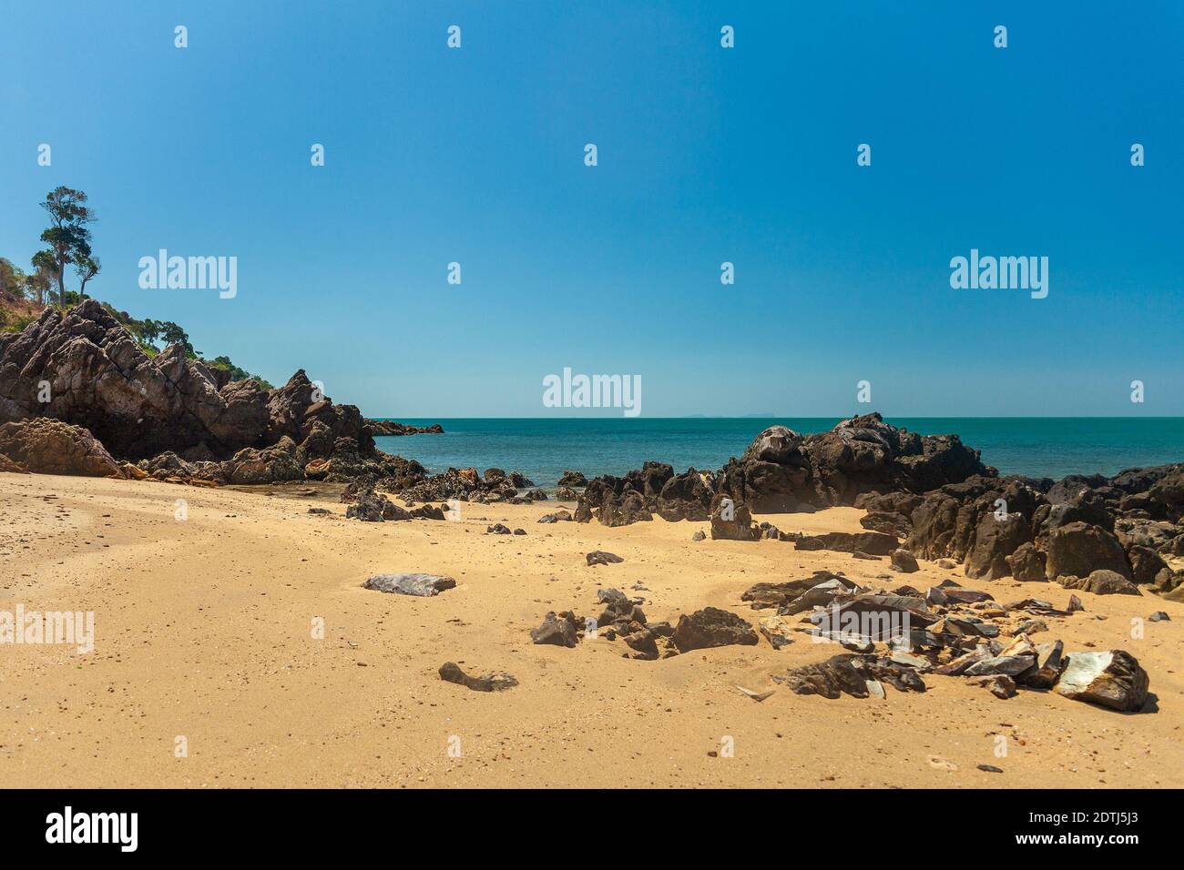 Beautiful deserted tropical beach with rocks Stock Photo - Alamy
